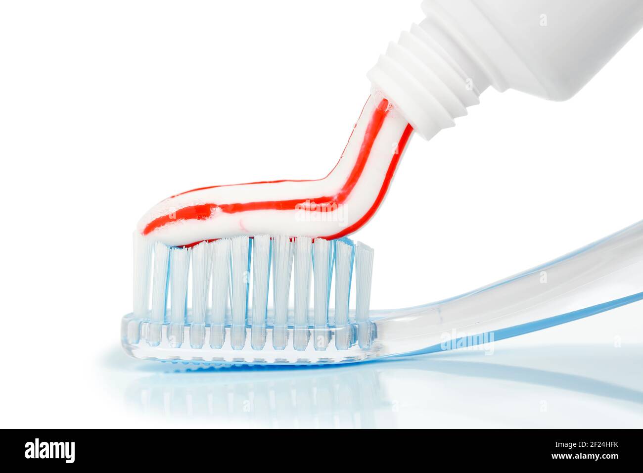 placing toothpaste on toothbrush isolated on white Stock Photo - Alamy