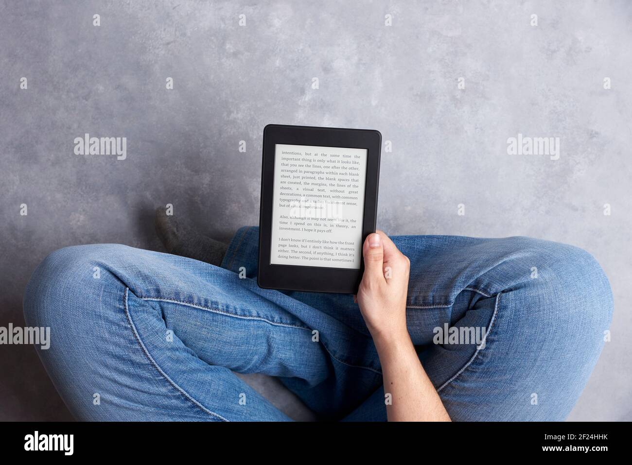 Subjective view of a young person reading a text on an electronic ...
