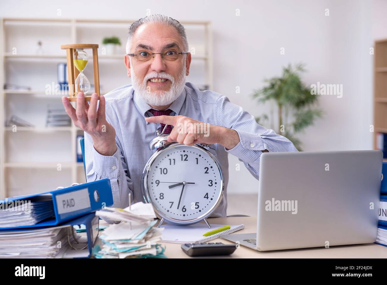 Old male accountant in budget planning concept in the office Stock ...
