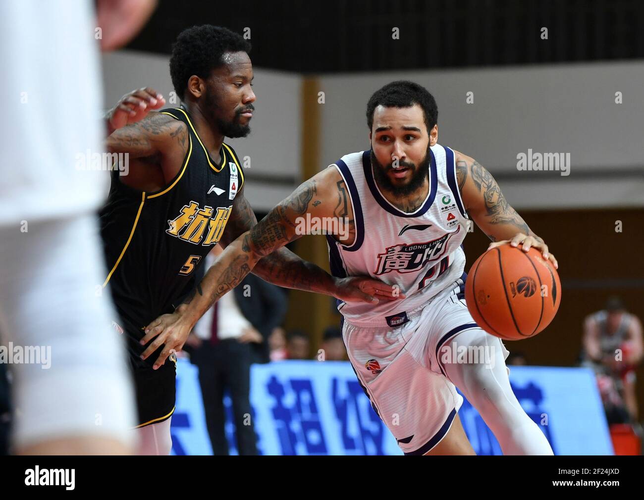 Zhuji, China's Zhejiang Province. 10th Mar, 2021. Dallas Moore (R) of ...