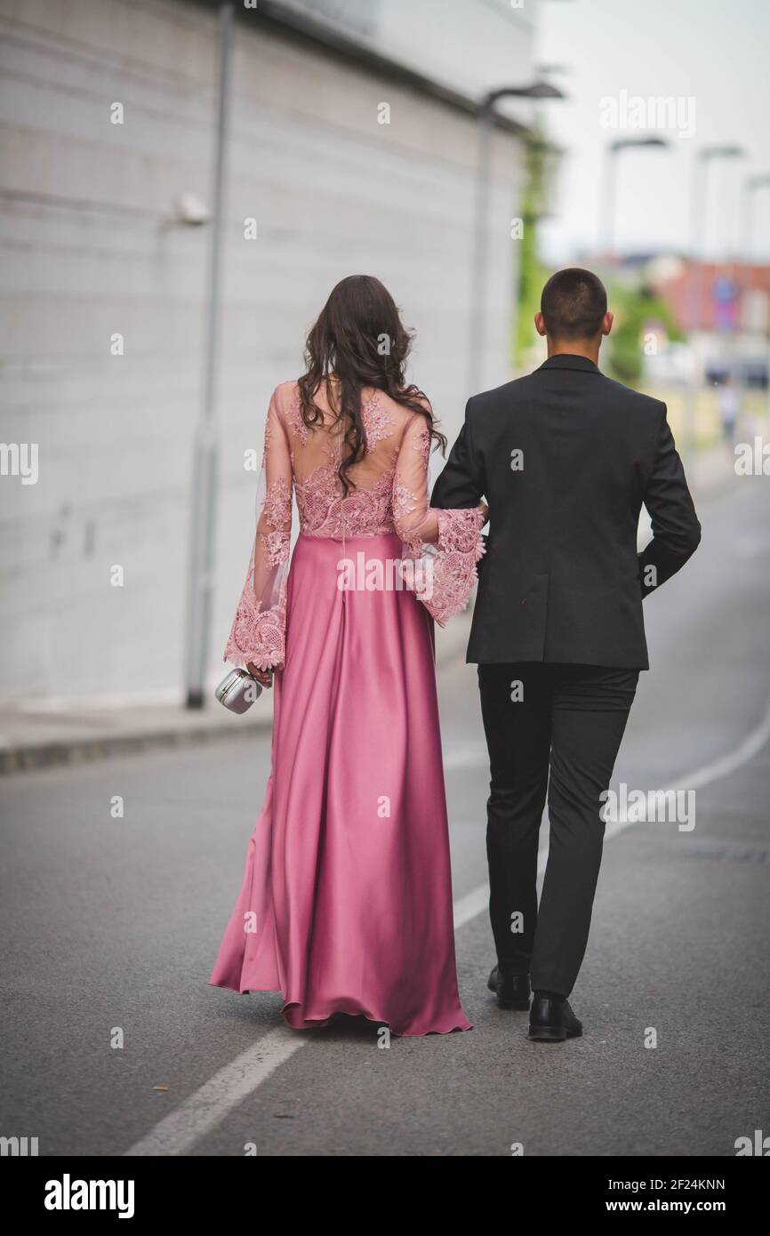 A shallow focus of a stylish elegant young couple walking through a ...
