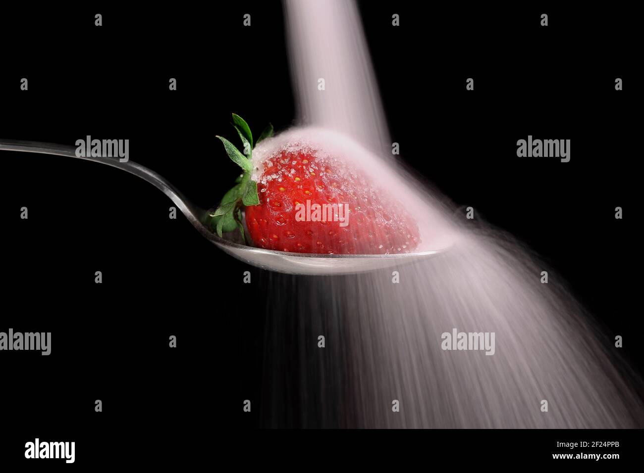 pouring sugar on strawberry, slow shutter speed Stock Photo - Alamy