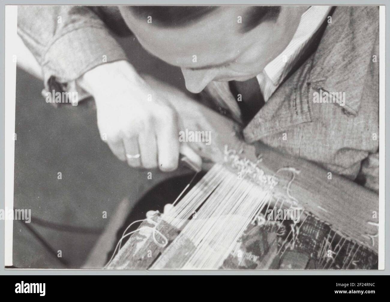 Man restores a carpet in the textile restoration studio .man restores a ...