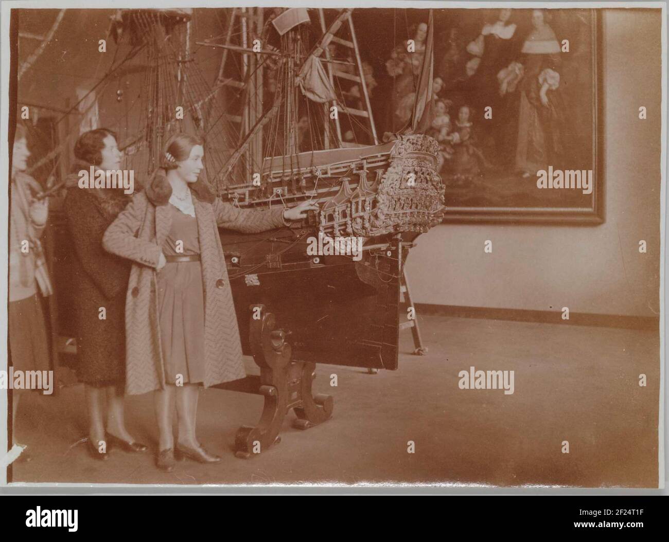 Three ladies posing at a model ship of the VOC in 1931.Driek ladies are ...