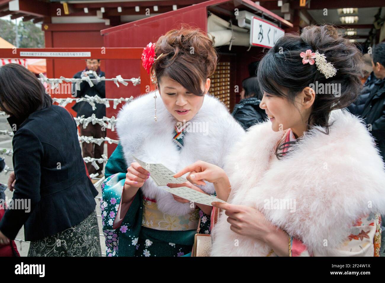 Pretty Japanese ladies in kimono and fa checking omikuji fortune telling on Coming of Age Day ...