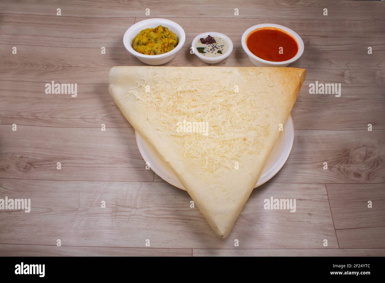 Rava dosa is a South Indian dish that is served with sambhar and ...