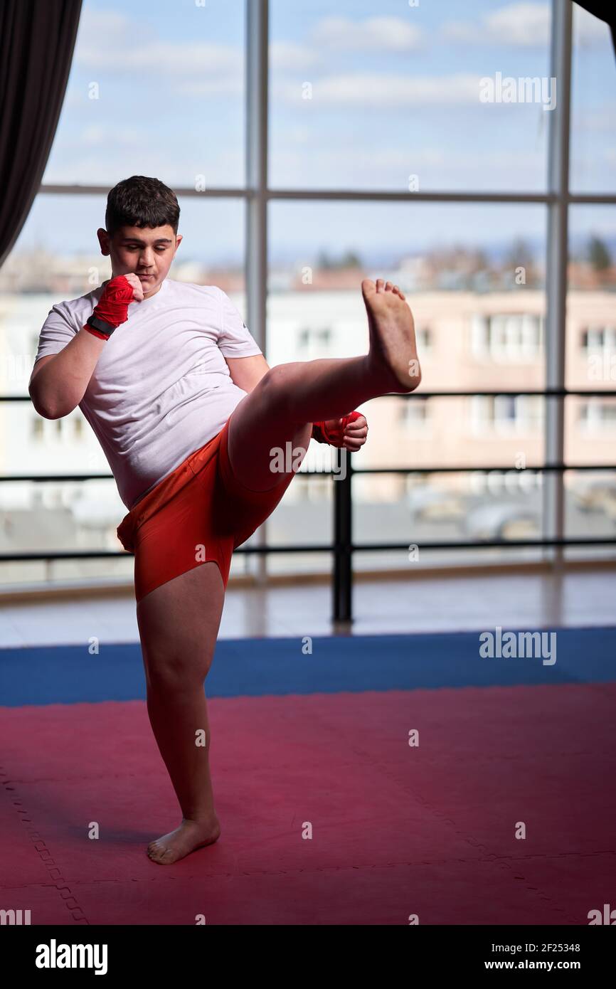 Overweight young kickboxer shadow boxing in the gym Stock Photo - Alamy