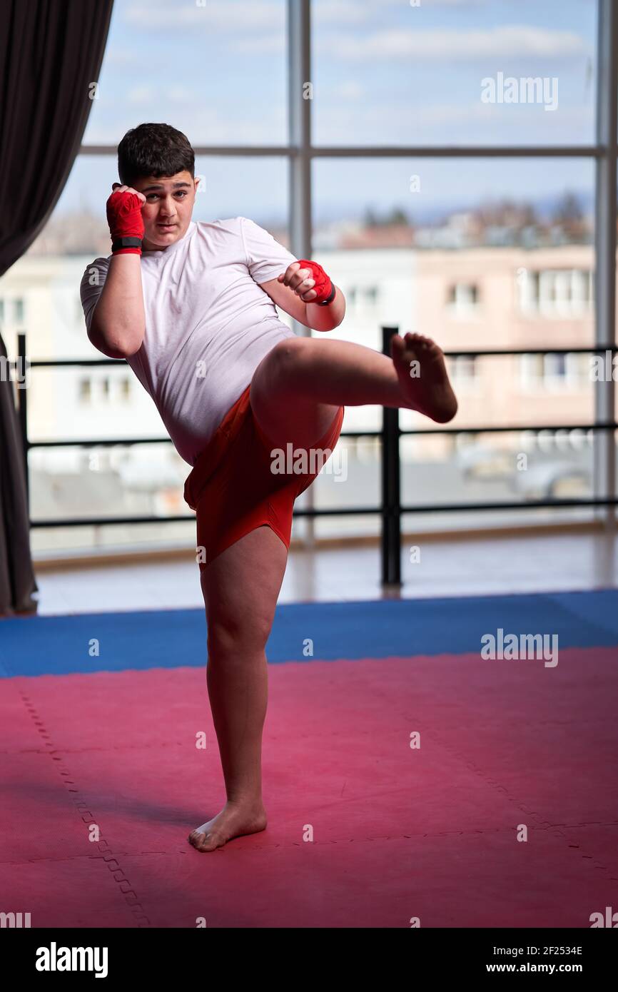 Overweight young kickboxer shadow boxing in the gym Stock Photo - Alamy