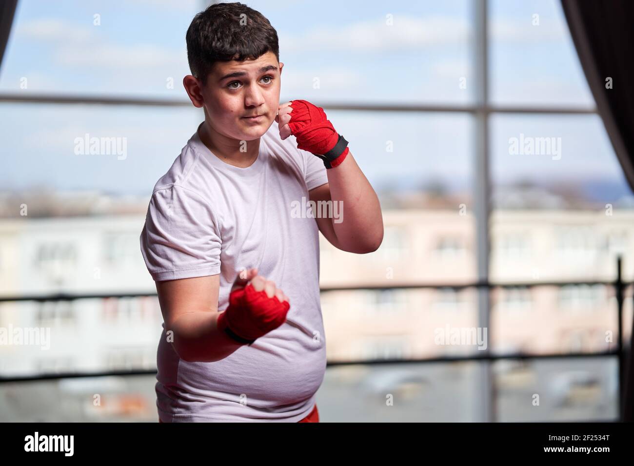Overweight young kickboxer shadow boxing in the gym Stock Photo - Alamy