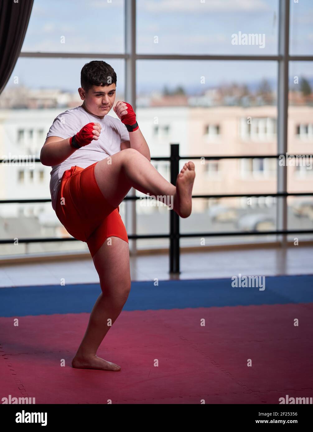 Overweight young kickboxer shadow boxing in the gym Stock Photo - Alamy