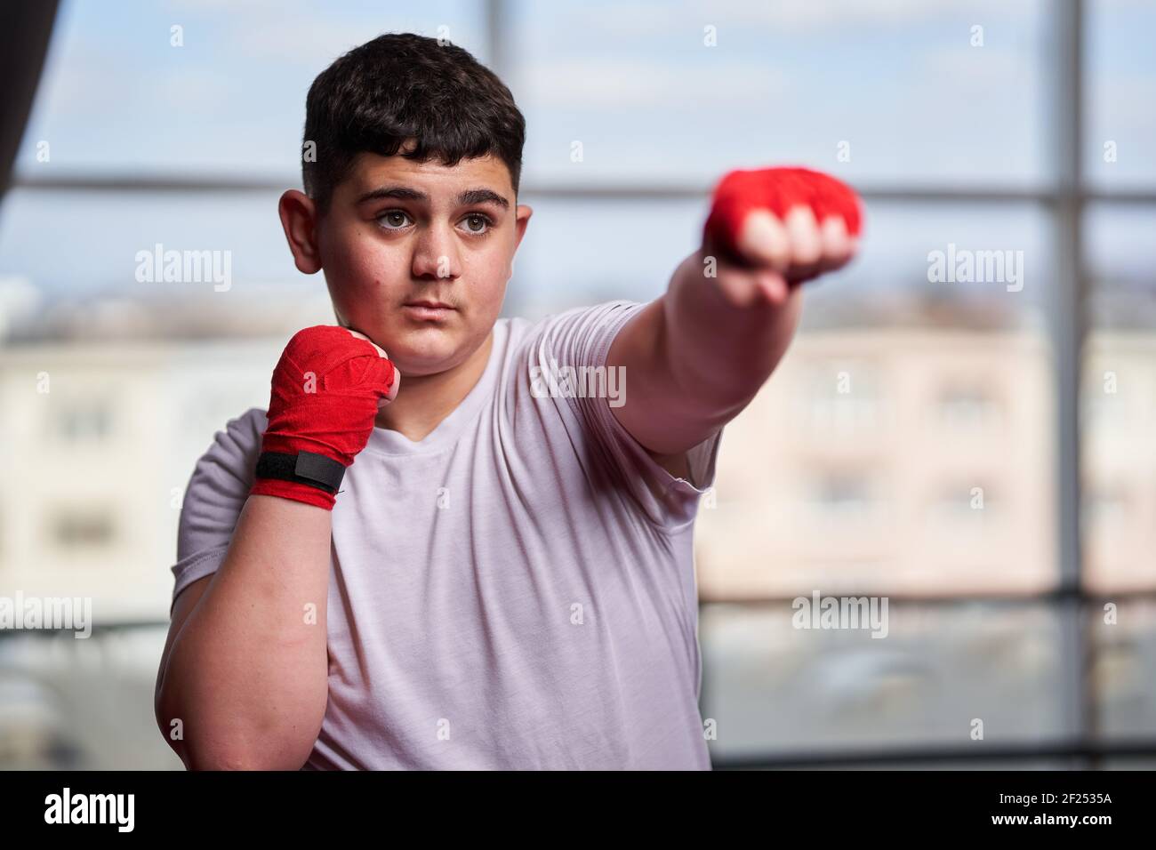 Overweight young kickboxer shadow boxing in the gym Stock Photo - Alamy