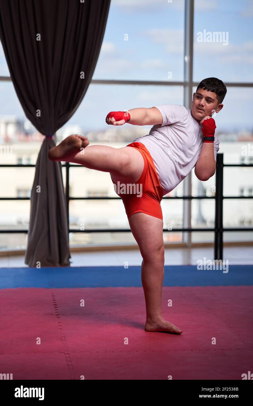Overweight young kickboxer shadow boxing in the gym Stock Photo - Alamy