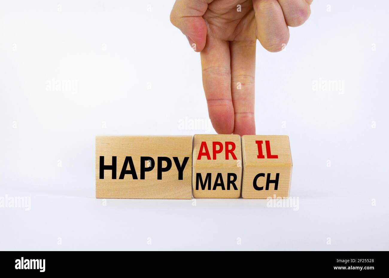 Symbol for the change from March to April. Businessman turns wooden ...