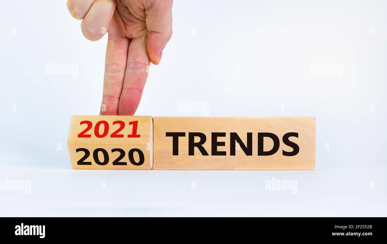 Business concept of new year 2021 trends. Businessman flips a wooden ...