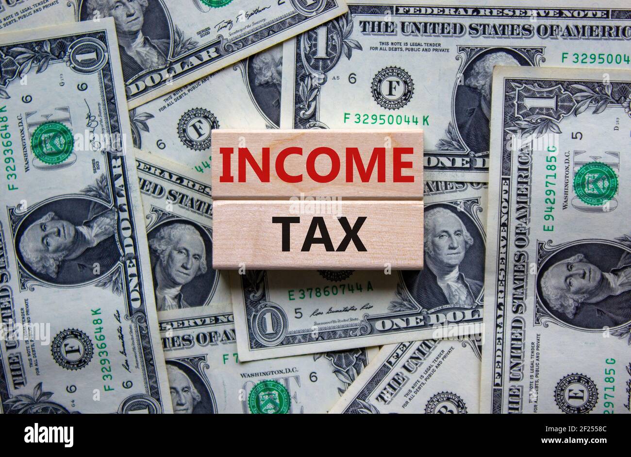 Income tax symbol. Concept words 'income tax' on wooden blocks on a ...