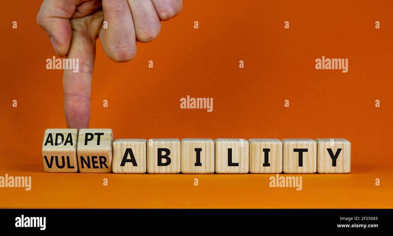 Vulnerability or adaptability symbol. Businessman turns cubes and ...
