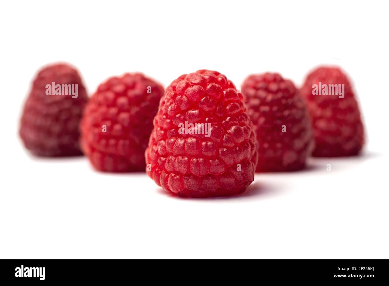 Fresh ripe raspberries on a white background - a group of five berries ...