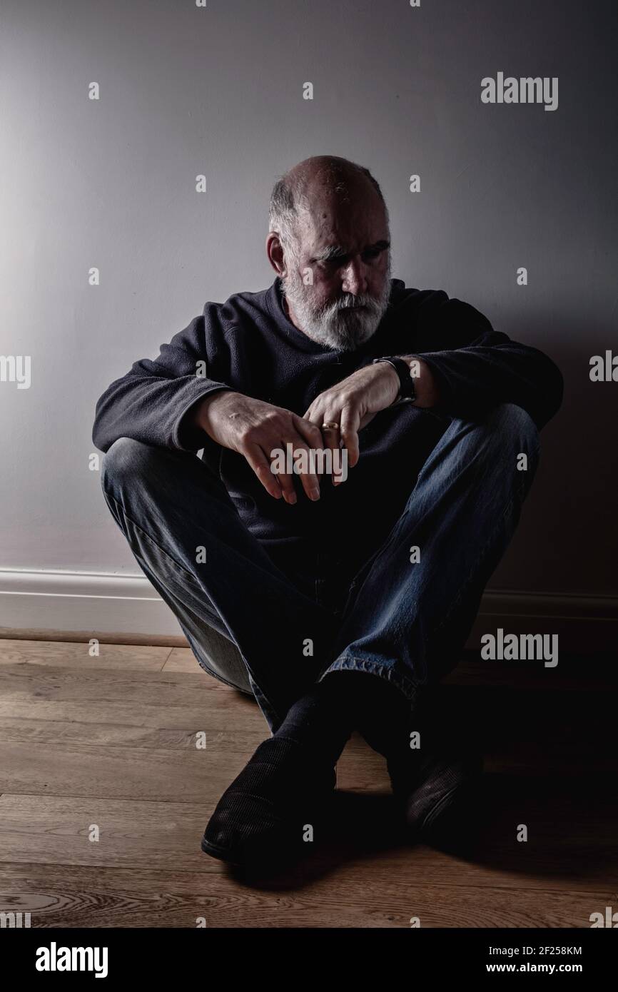 Sad man sitting cross legged hi-res stock photography and images - Alamy
