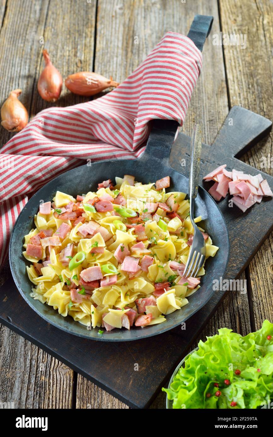 Austrian ham pasta, so called Schinkenfleckerl, served in an iron ...