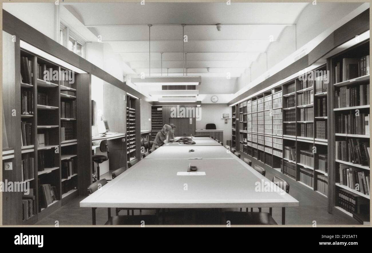 Space with cupboards, tables, people and picture standards; Interior ...