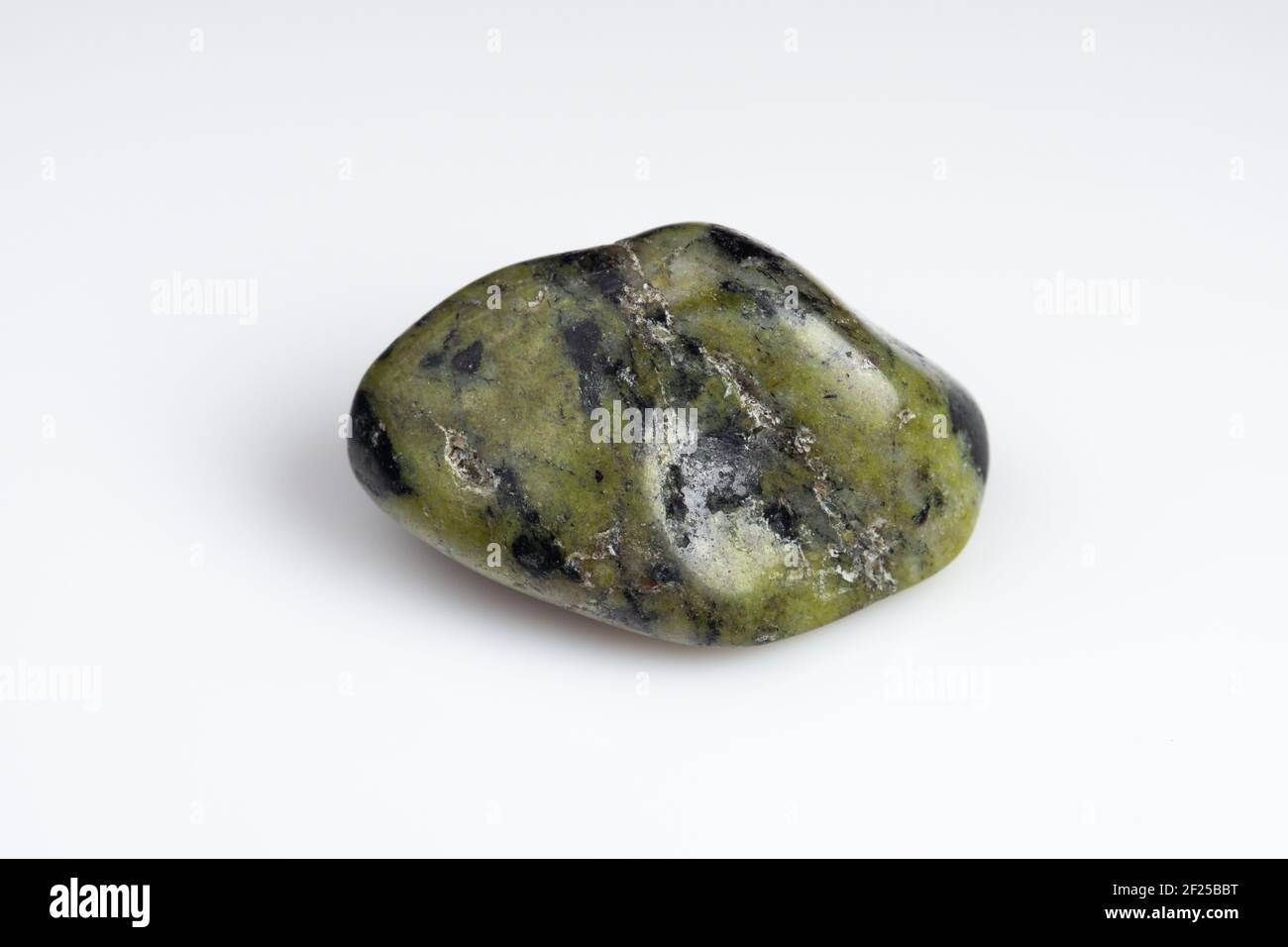 Natural stone green serpentine on a white background Stock Photo - Alamy