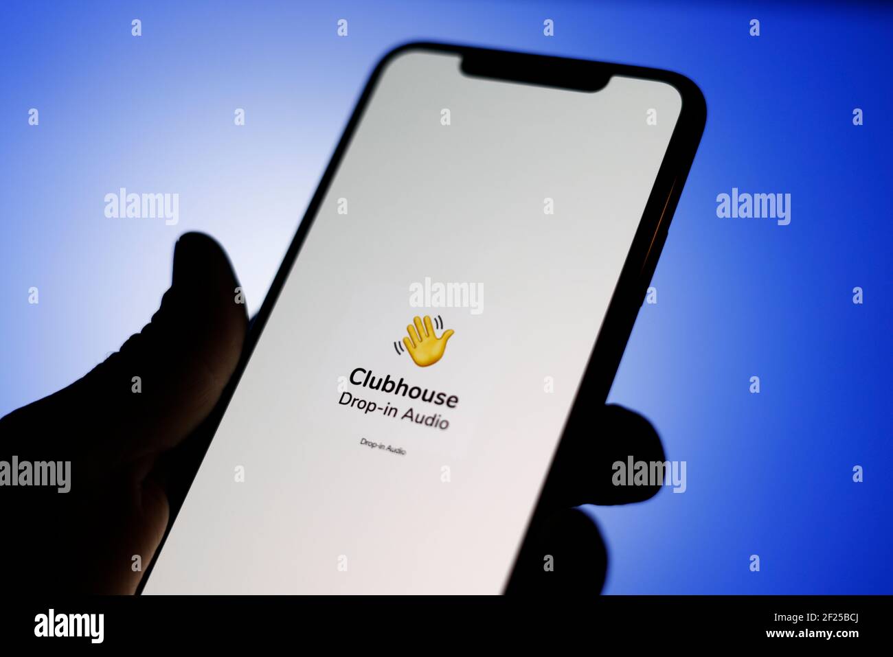 The Clubhouse application logo is seen on an iPhone screen in this ...