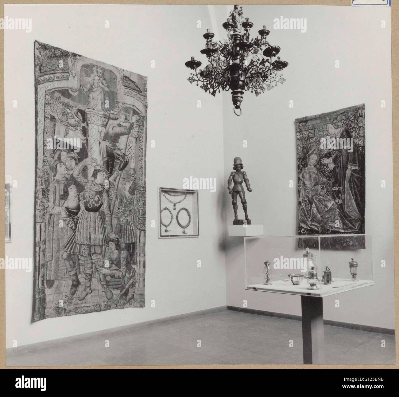 Room with 15th and 16th century sculptures, tapestries, a candle crown ...