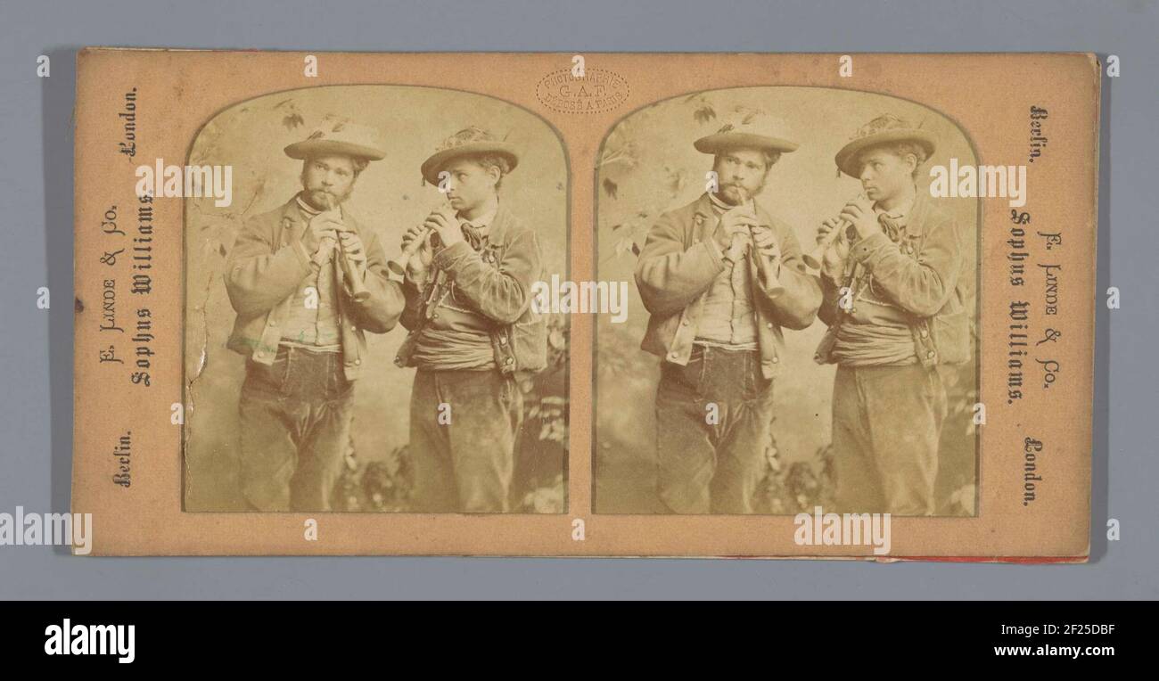 Two young men in traditional costumes play wind instruments Stock Photo ...