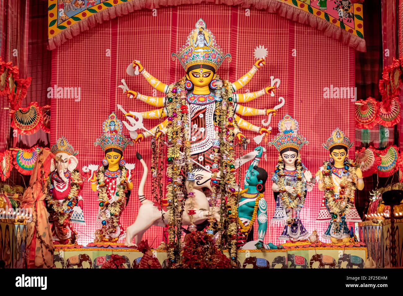 Goddess Durga idol at decorated Durga Puja pandal, shot at colored light, at Kolkata, West ...