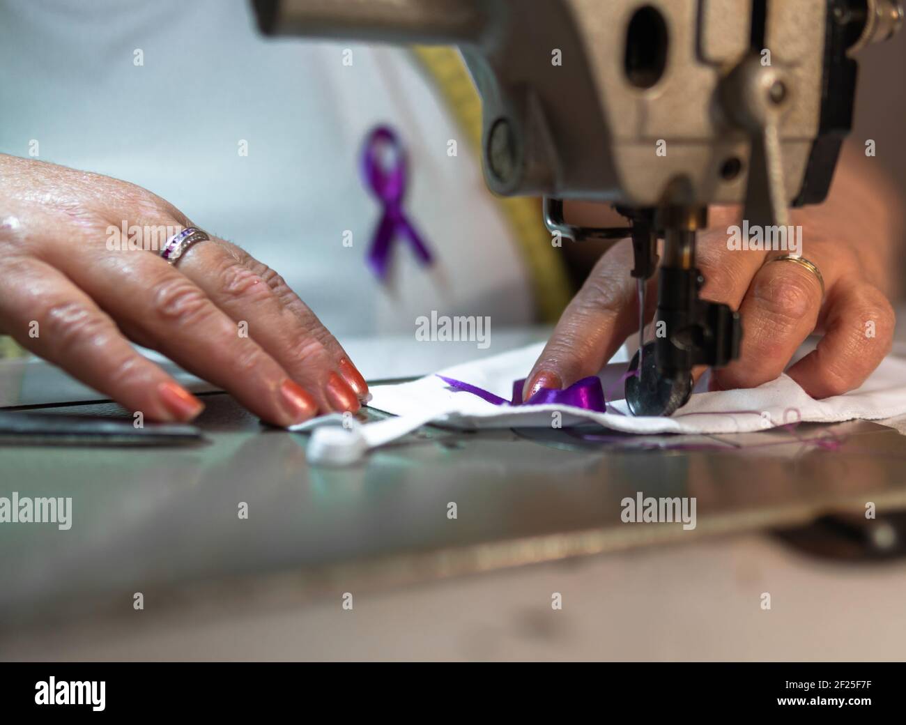 Adult woman sewing purple hi-res stock photography and images - Alamy