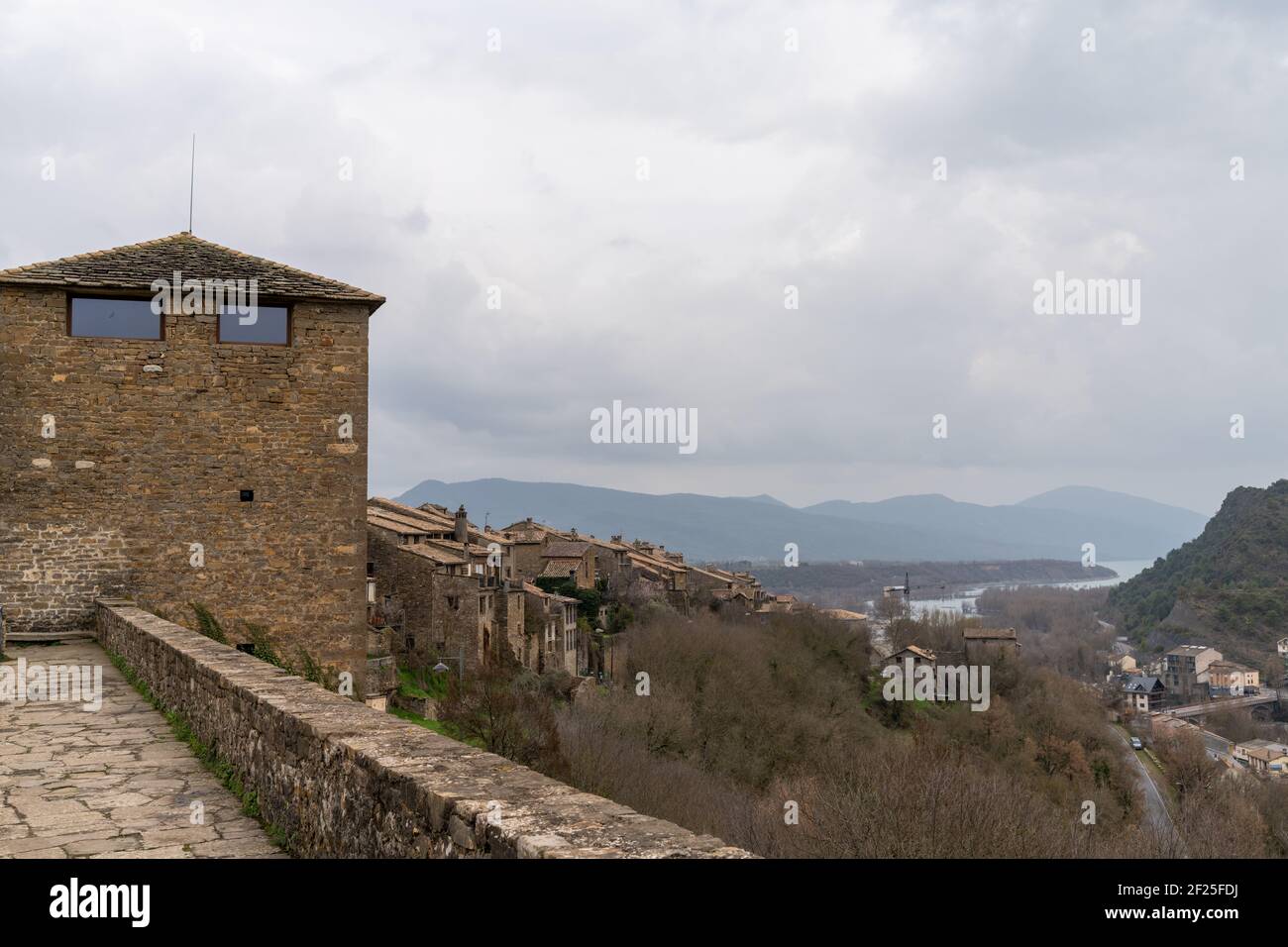 A view of the castle wall and village of Ainsa in the Pyrenees of Spain ...
