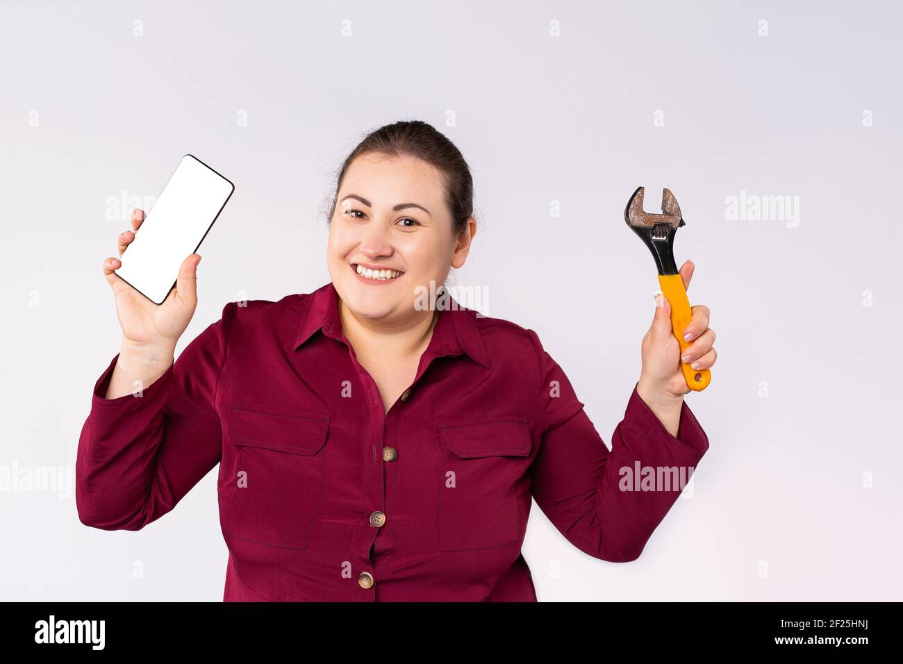 Online promotion concept. Smiling woman holding a repair tool and a ...
