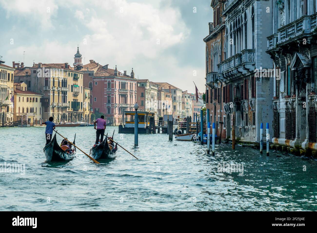 Gondoliers ferrying people in Venice Stock Photo - Alamy