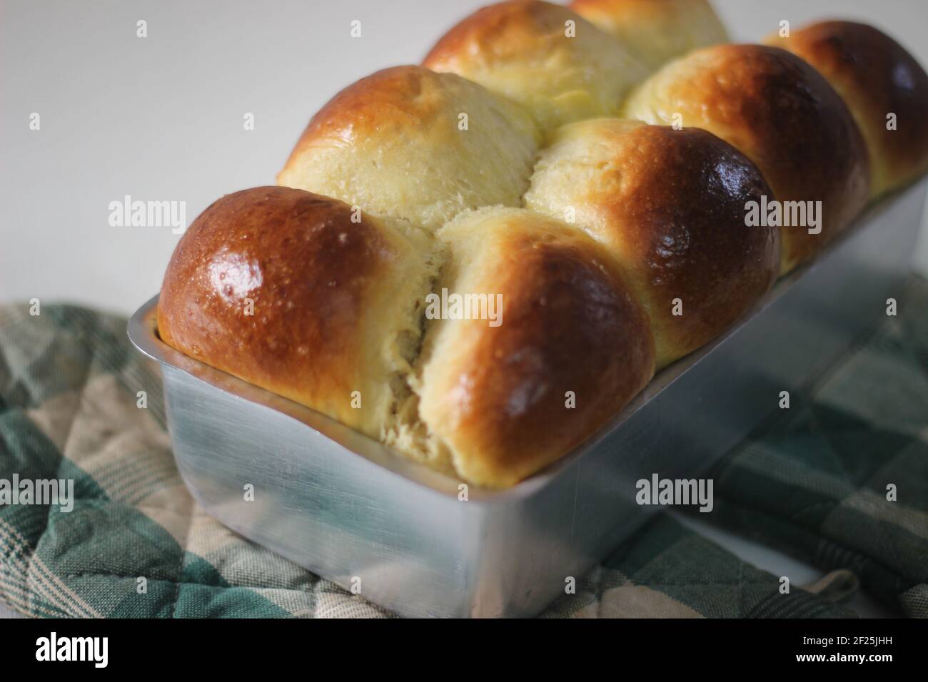 Freshly Home baked Brioche bun loaf inside the loft tin. Shot on white ...