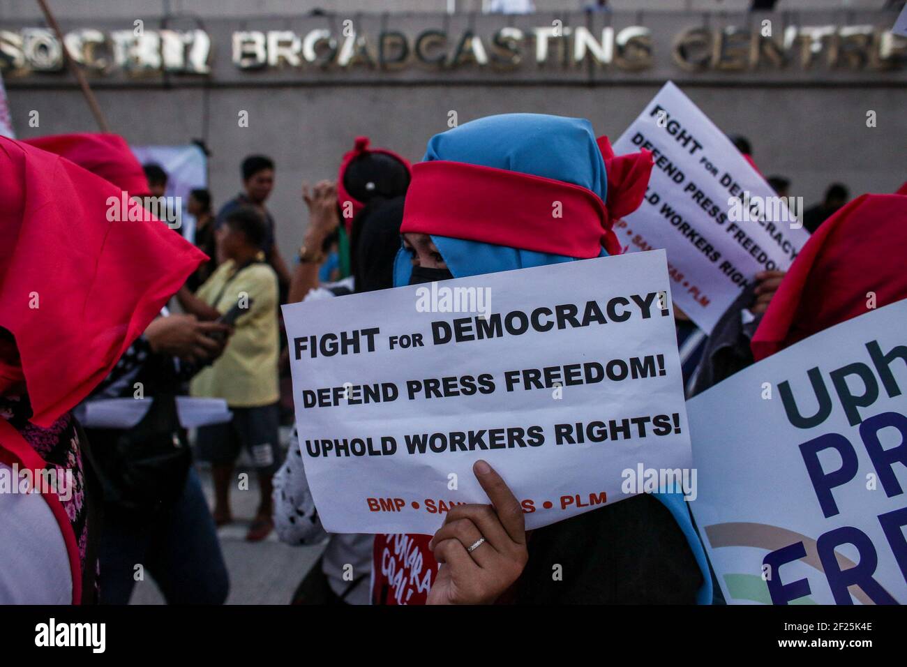 Protesters hold placards during a rally on press freedom following ...
