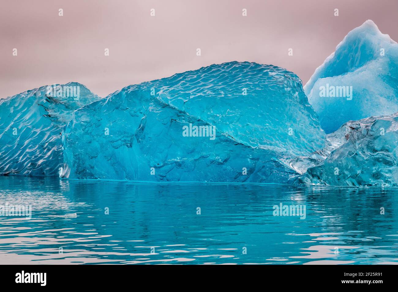 Blue iceberg just after flipping in water, Iceland Stock Photo - Alamy