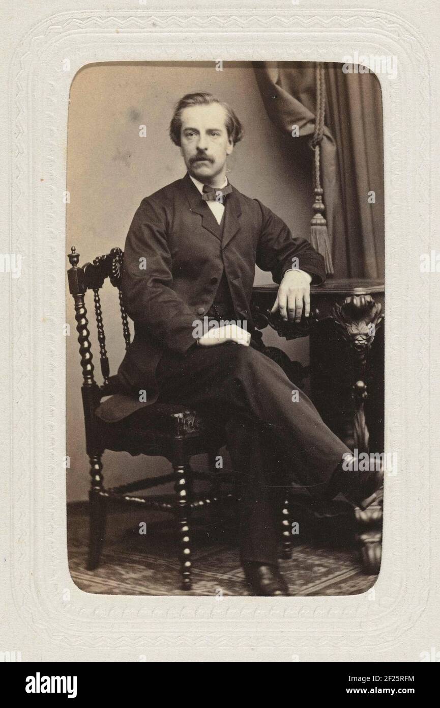 Studio portrait of a man with mustache on a chair Stock Photo - Alamy