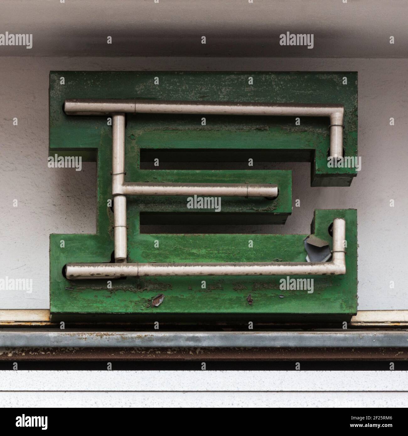 White neon letter E on green metal letter Stock Photo - Alamy