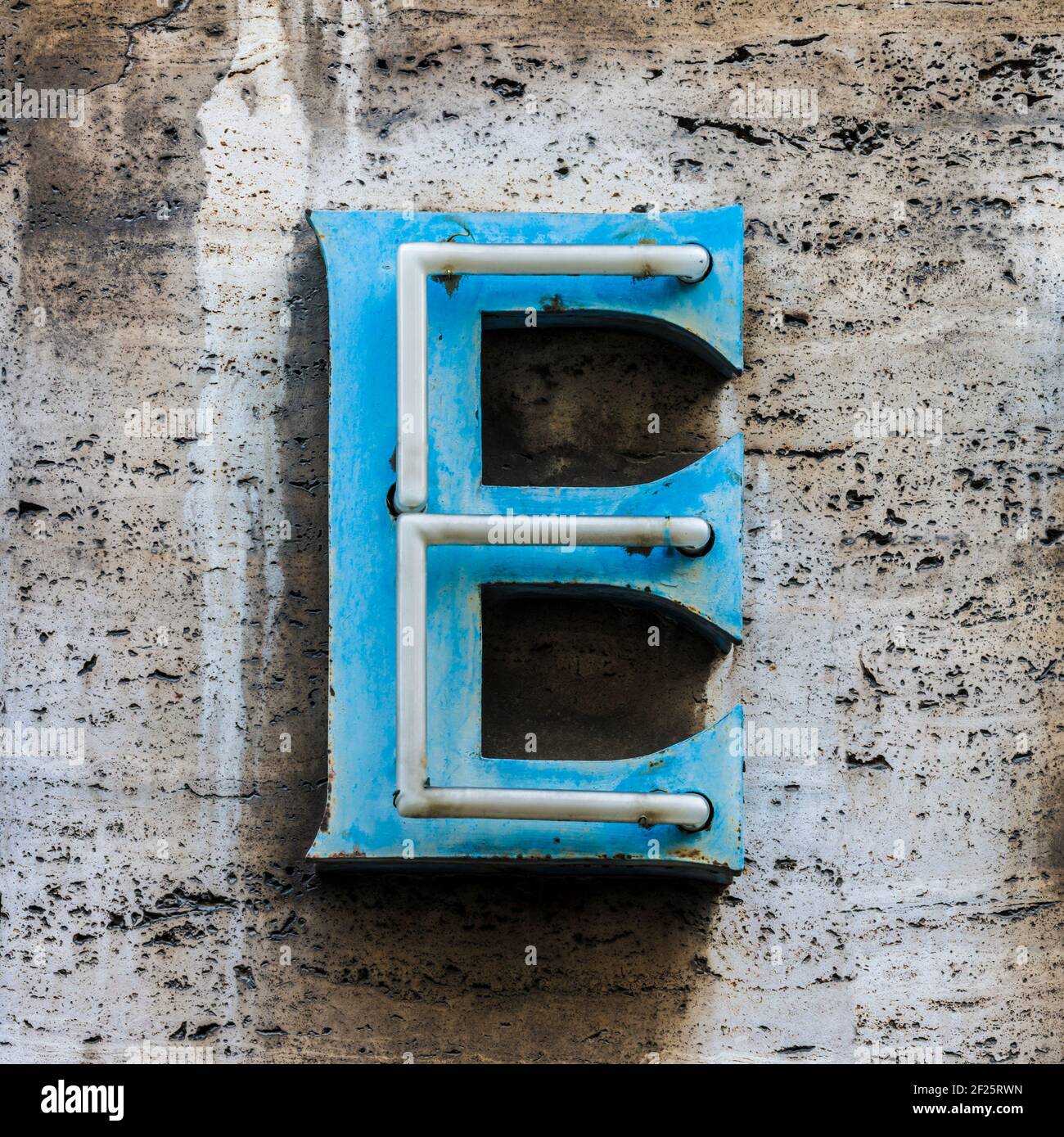 Old neon letter E in turquoise colour Stock Photo - Alamy