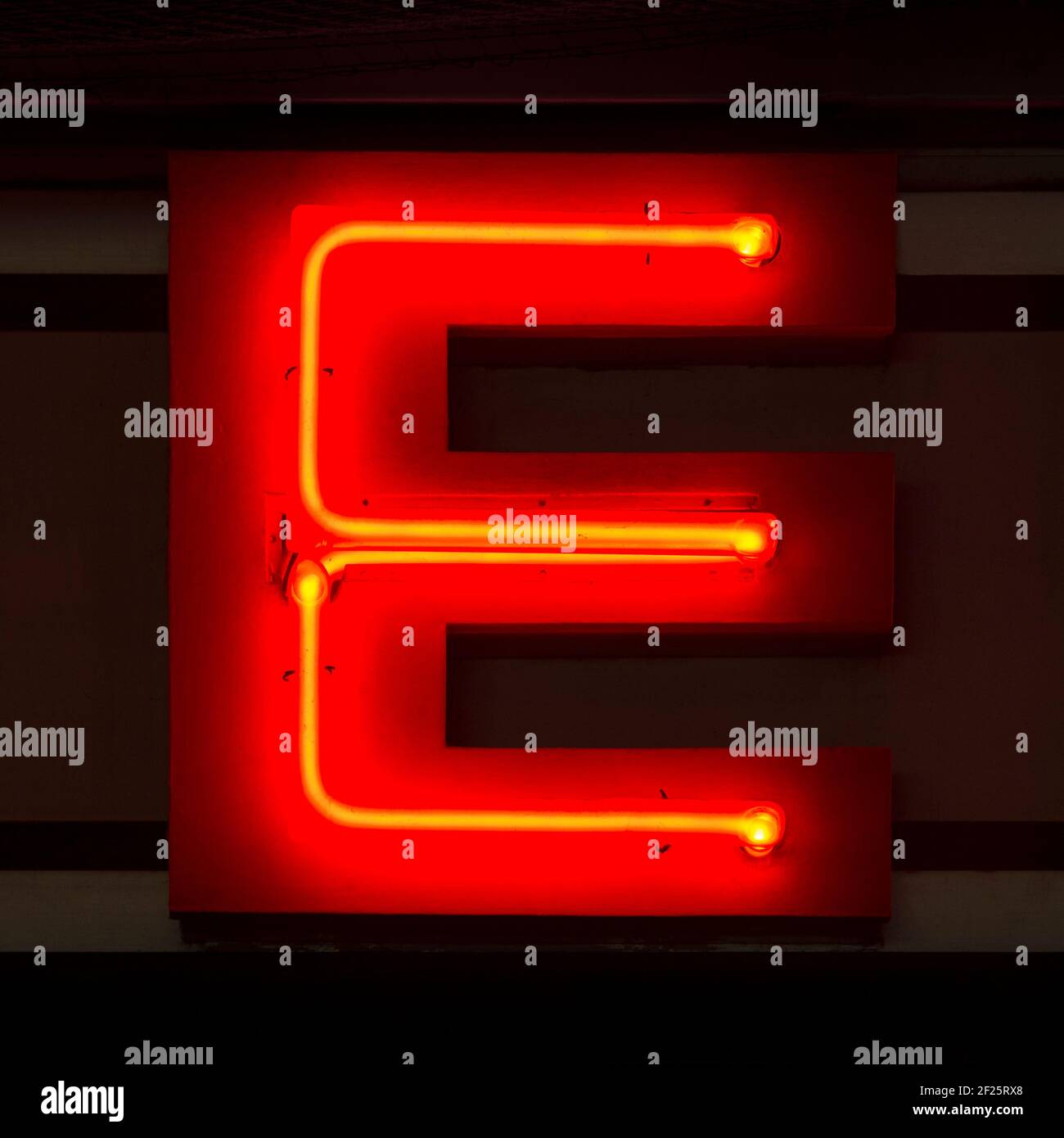 Red glowing neon letter E at night Stock Photo - Alamy