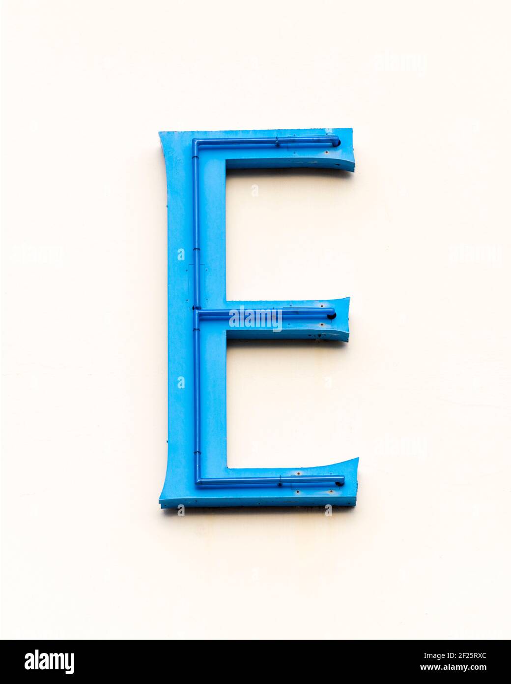 Blue letter E with serifs and dark blue neon tubes Stock Photo - Alamy