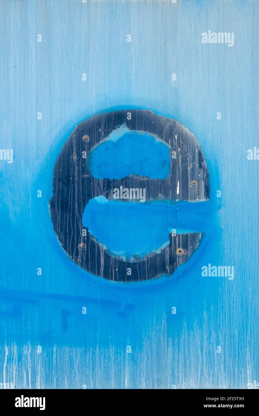 Traces of a disappeared letter e on washed-out blue surface Stock Photo ...