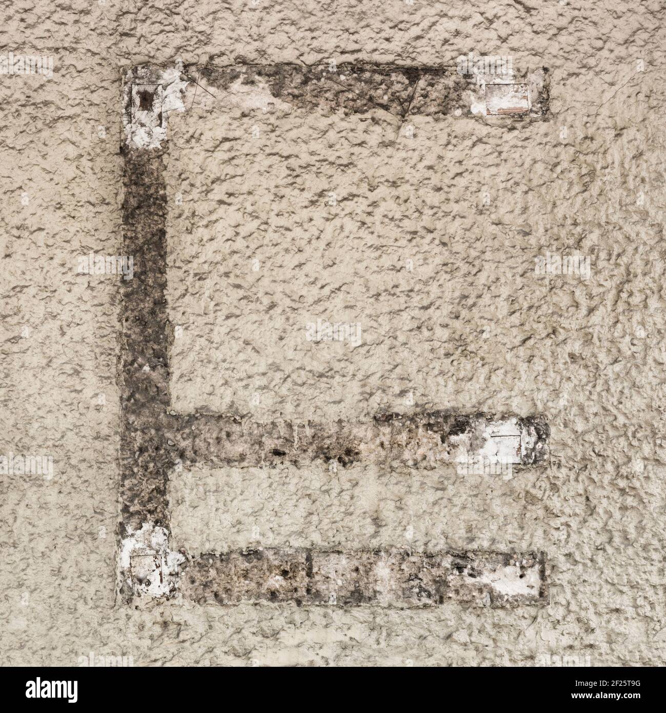 Remains of a lost capital letter E Stock Photo - Alamy