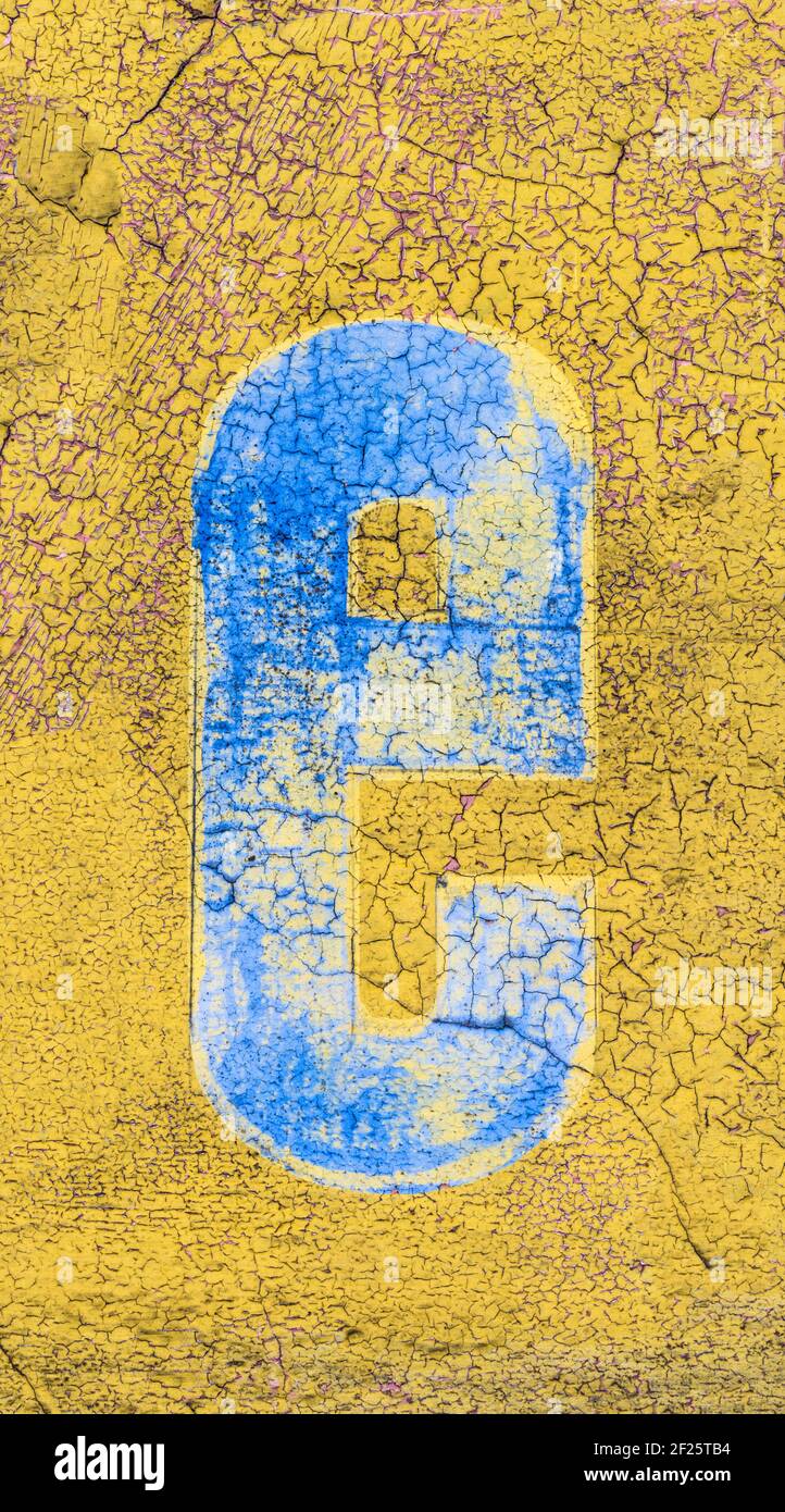 Cyan blue letter e painted on yellow wall Stock Photo - Alamy