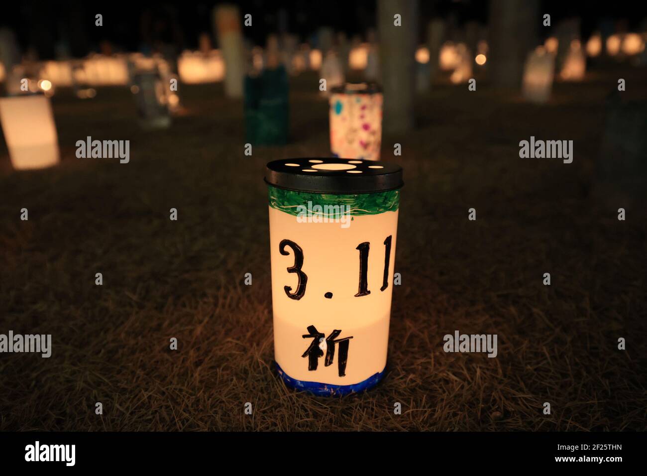 Futaba, Japan. 10th Mar, 2021. A candle shows "3.11 pray" as volunteers ...