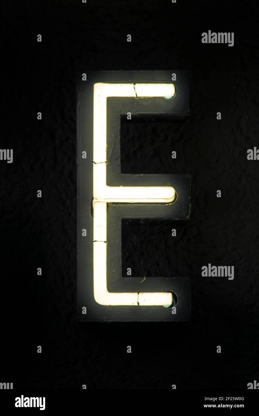 White neon letter E in the dark Stock Photo - Alamy