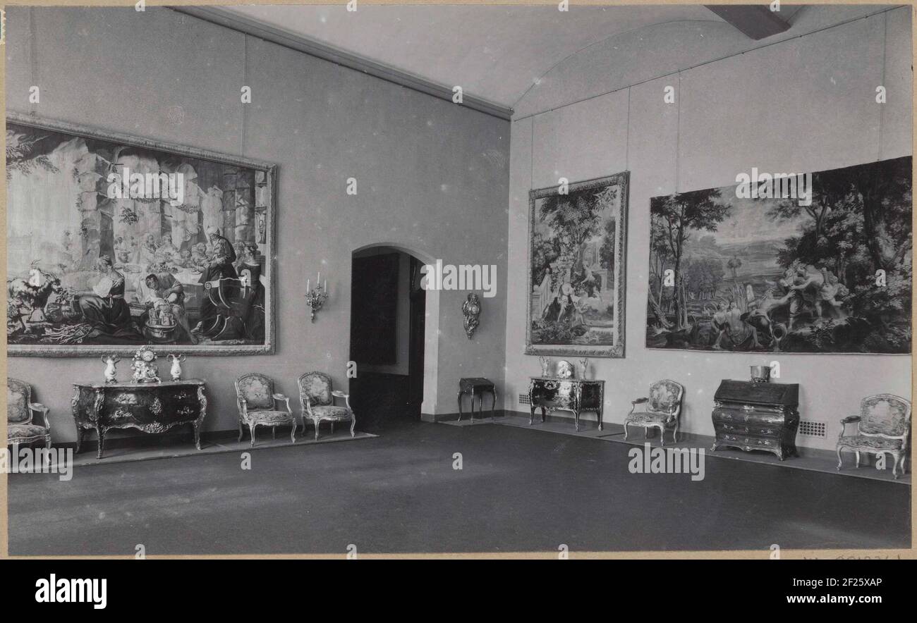 Room with objects on a wall including cupboards and chairs; Exhibition ...