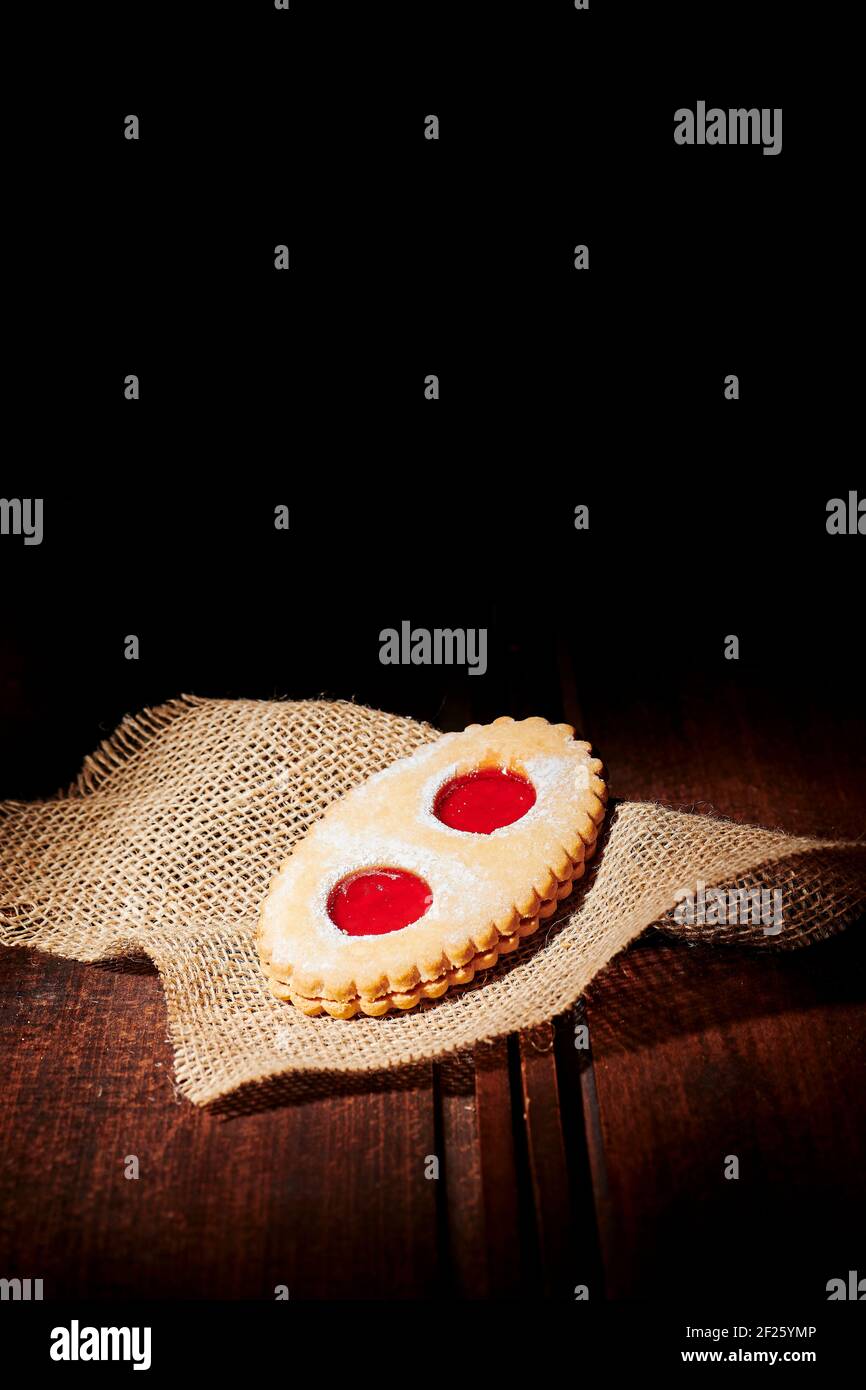 two biscuits on black background restaurant france Stock Photo - Alamy