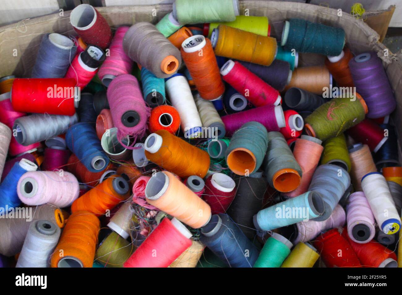 different color spools of thread for the textile industry. background ...