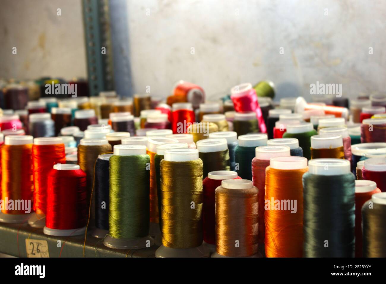 different color spools of thread for the textile industry. background ...